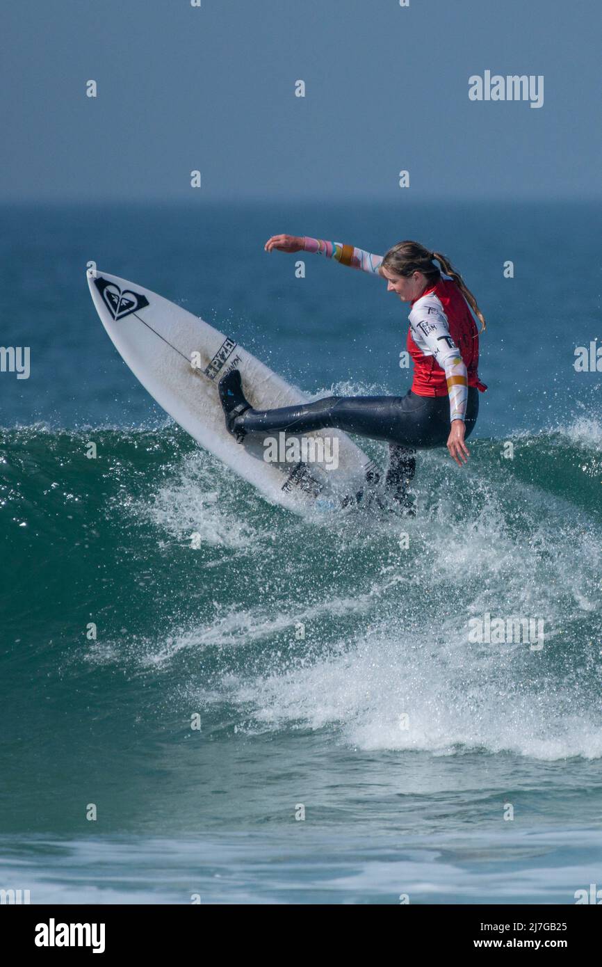 A female surfer competing in a surfing competition at Fistral in ...