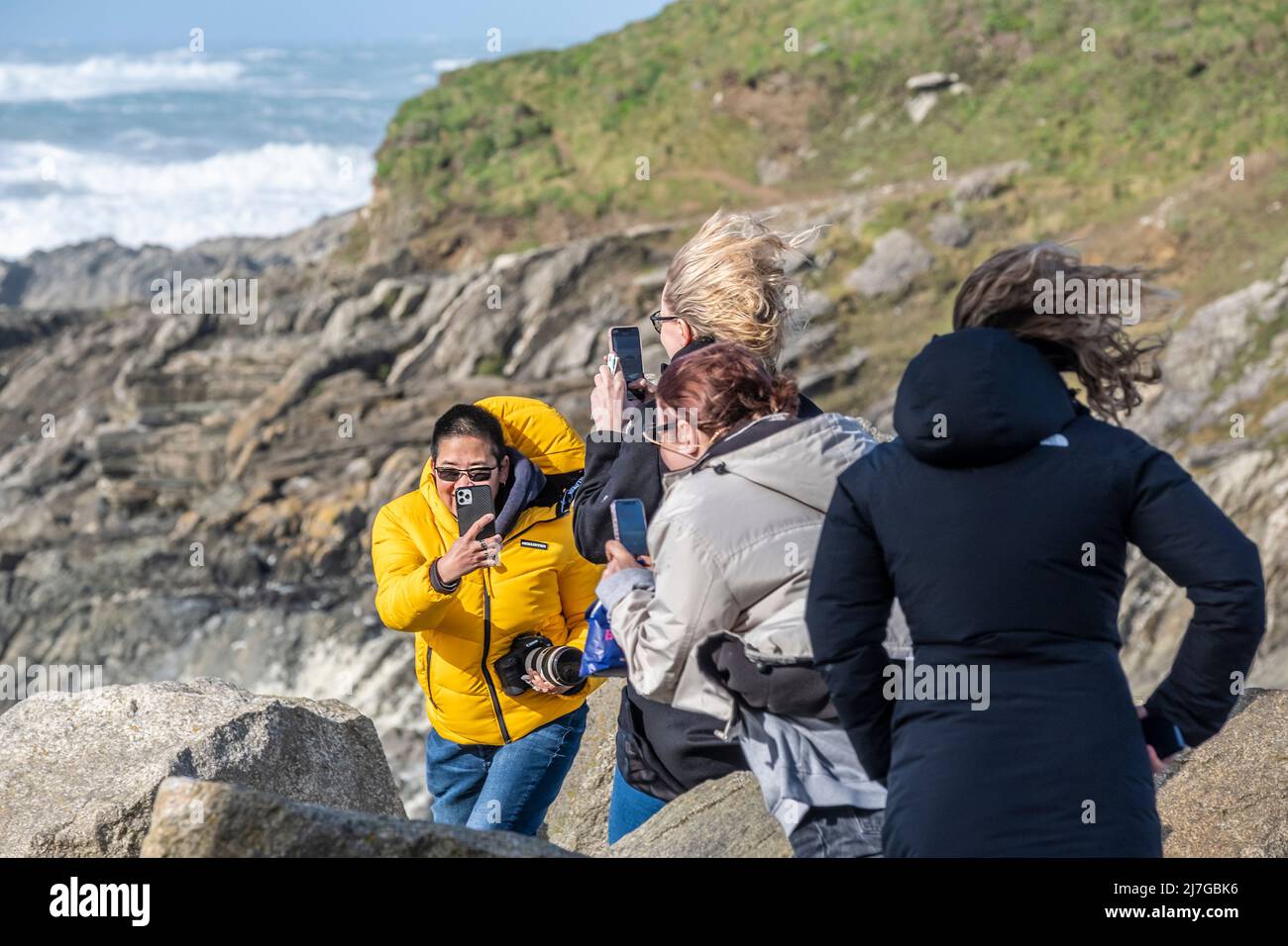 People using their mobile phones to record the storm force wind caused ...