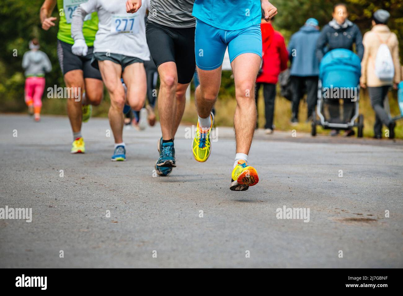 legs group male runners athletes run road Stock Photo - Alamy