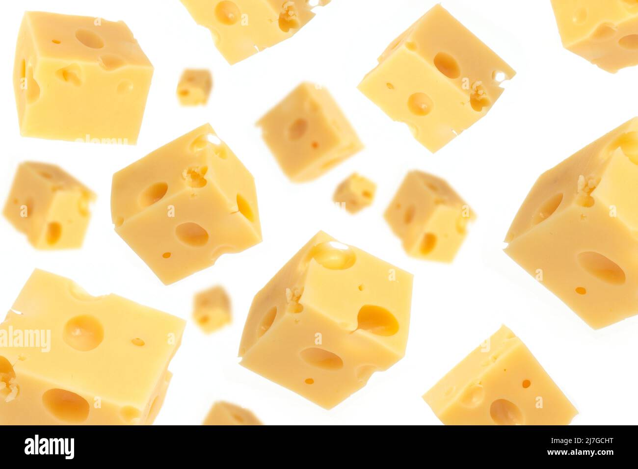 Falling cheese cubes, isolated on white background, selective focus ...