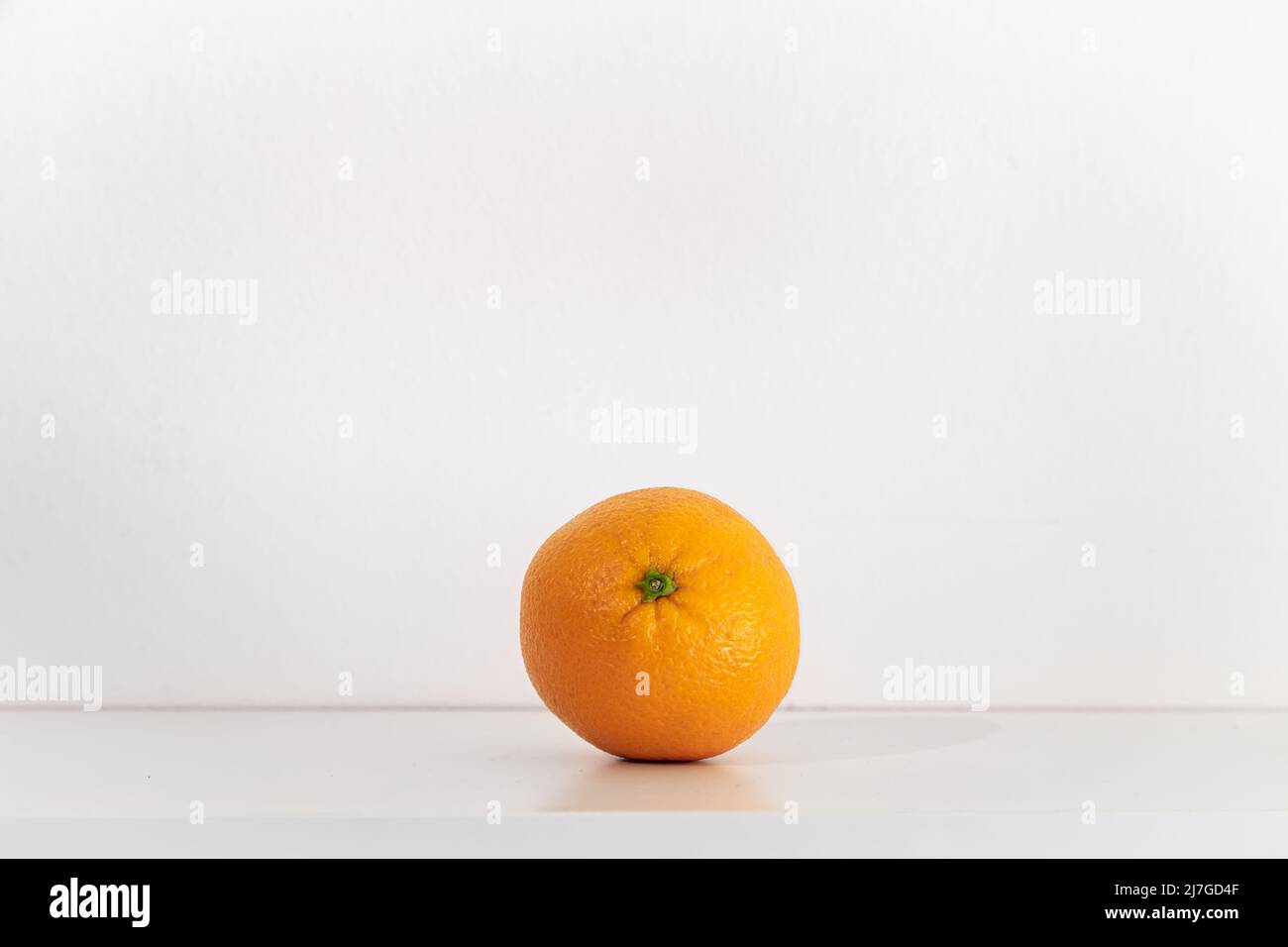 One orange on a white background isolated Stock Photo - Alamy