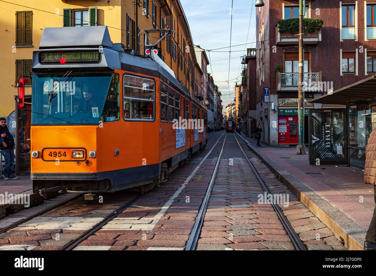 Orange tram full of passengers through the streets of the center of ...