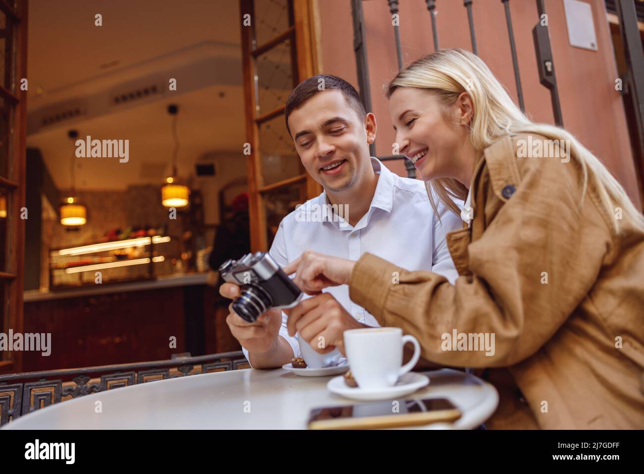 Happy friends watching photos on hi-res stock photography and images ...