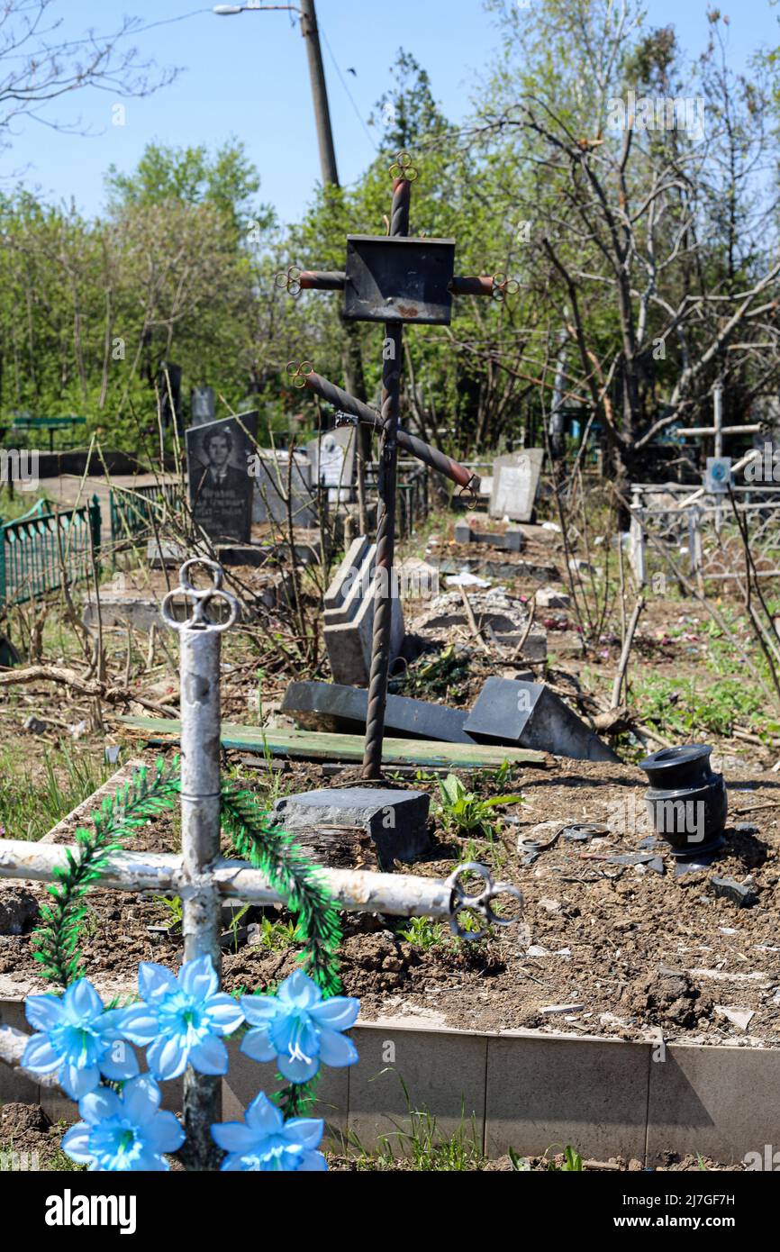 The burnt cross and ruined graves during the Russia-Ukraine war ...