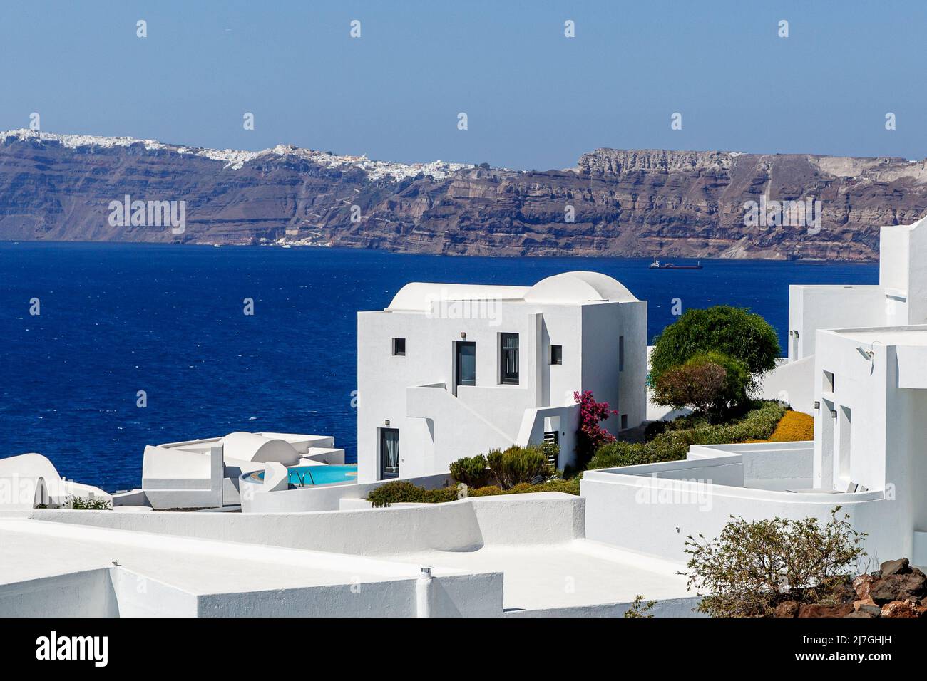 Traditional greek white houses on Santorini coast near the Aegean Sea ...