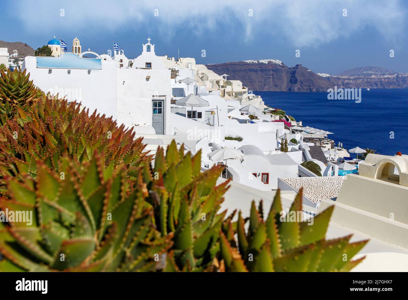 Traditional greek white houses on Santorini coast near the Aegean Sea ...