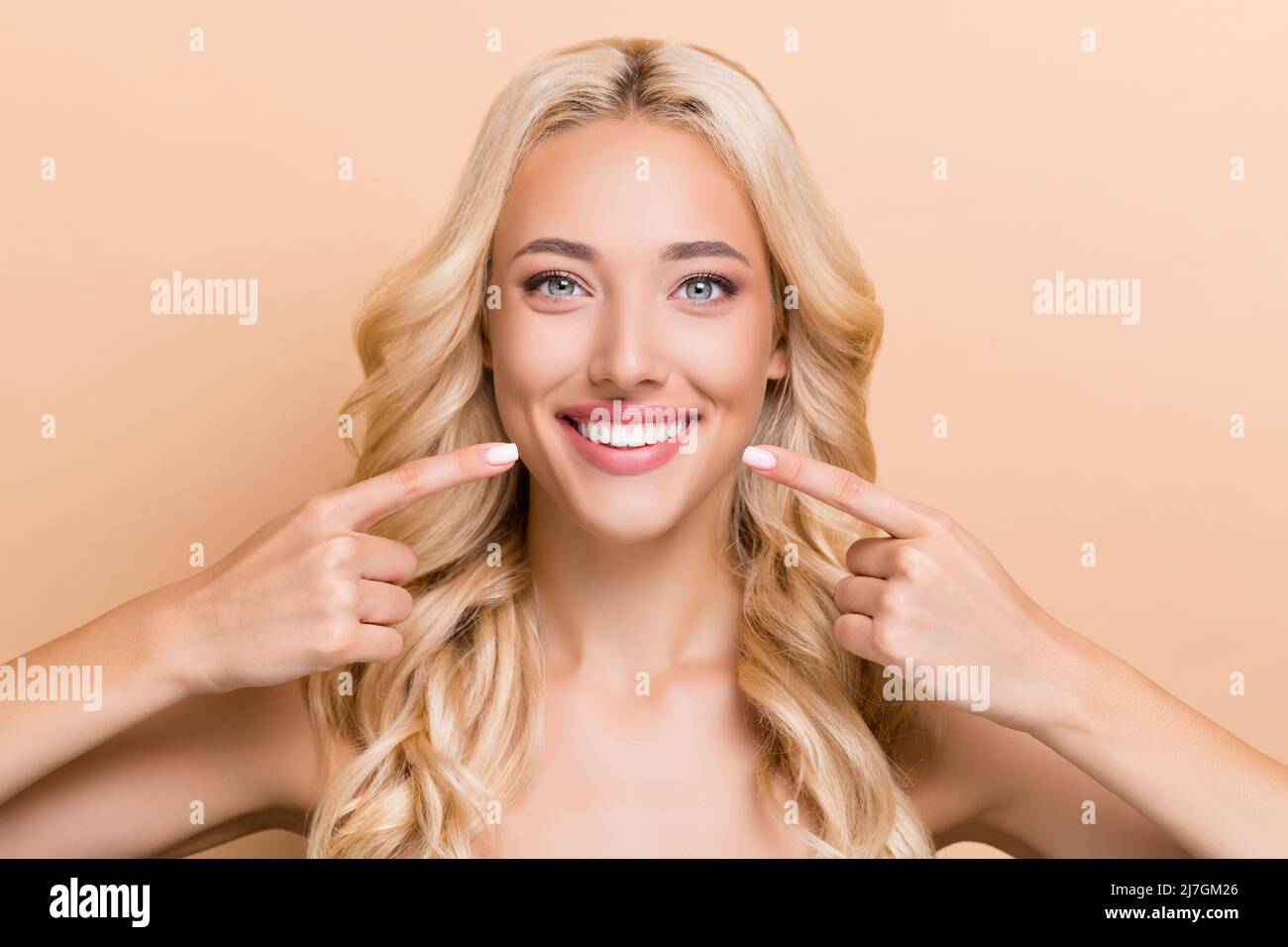 Portrait of attractive cheerful wavy-haired girl demonstrating perfect ...