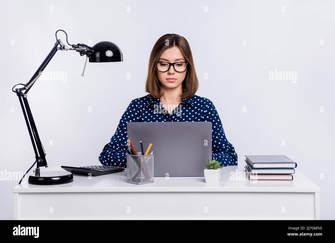 Portrait of calm concentrated focused girl use wireless digital netbook ...