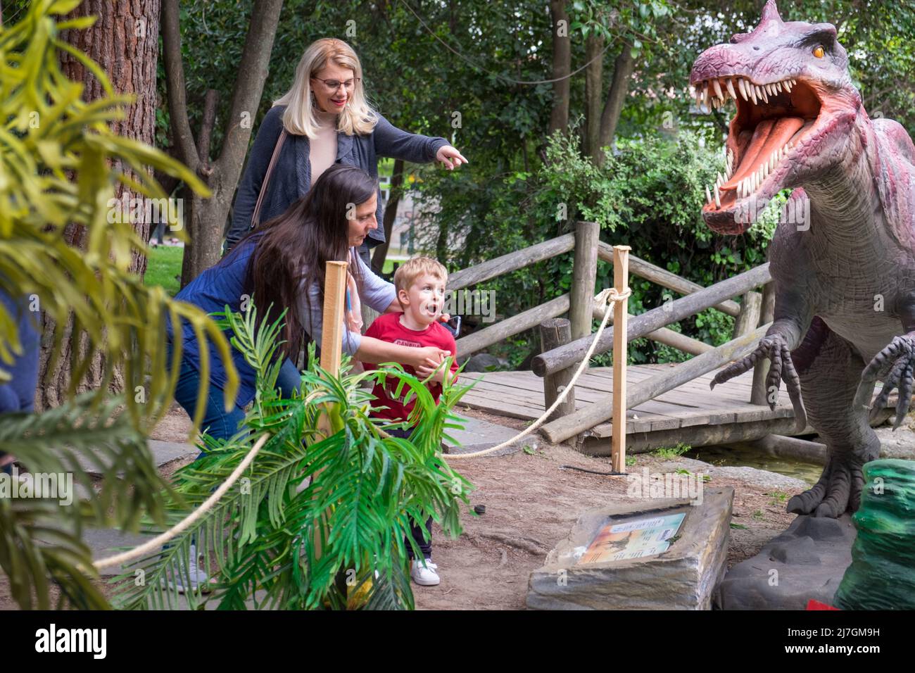 Cute little boy having fun with dinosaurs in a dinosaur festival Stock ...