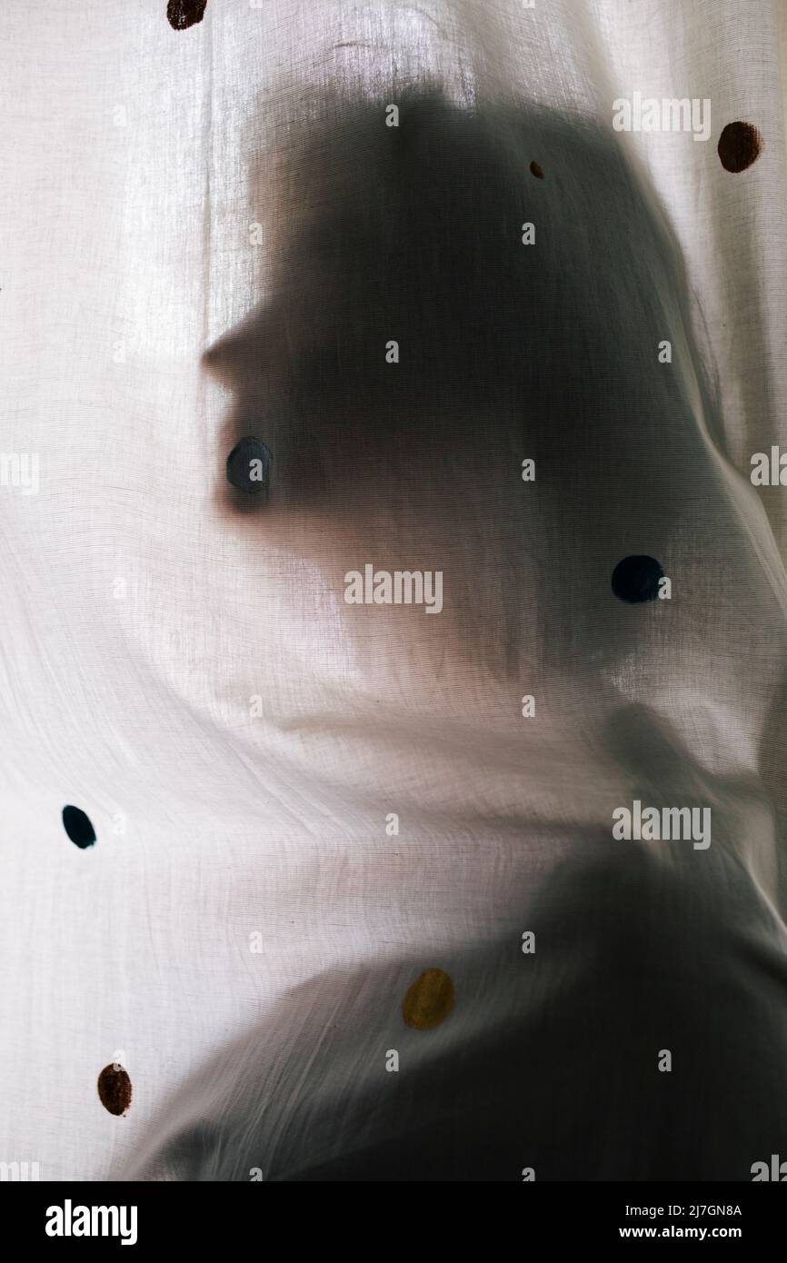 Shadow of senior woman behind curtain at home Stock Photo - Alamy