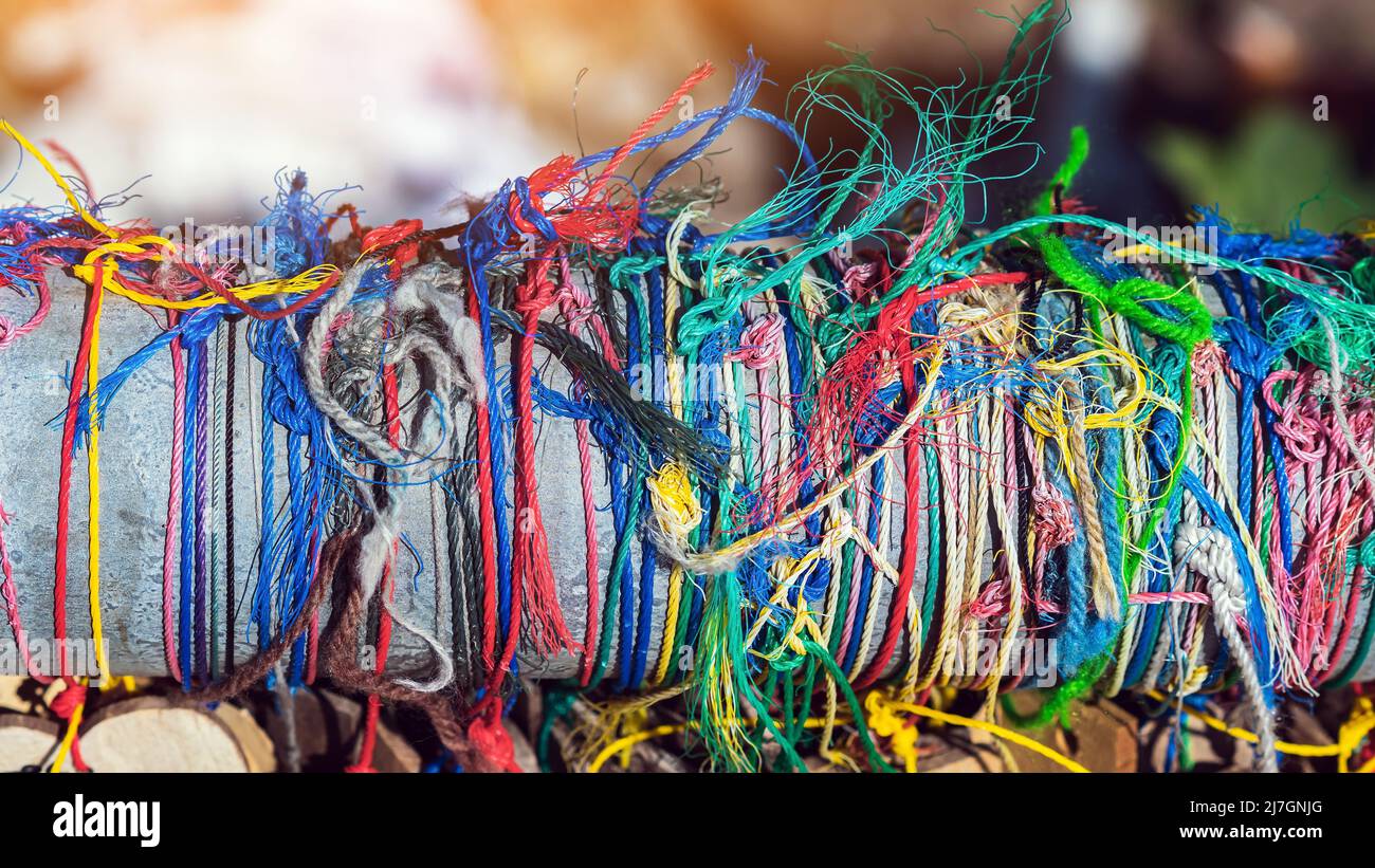 Many suspended chaotically intertwined colorful ropes tied into messy ...