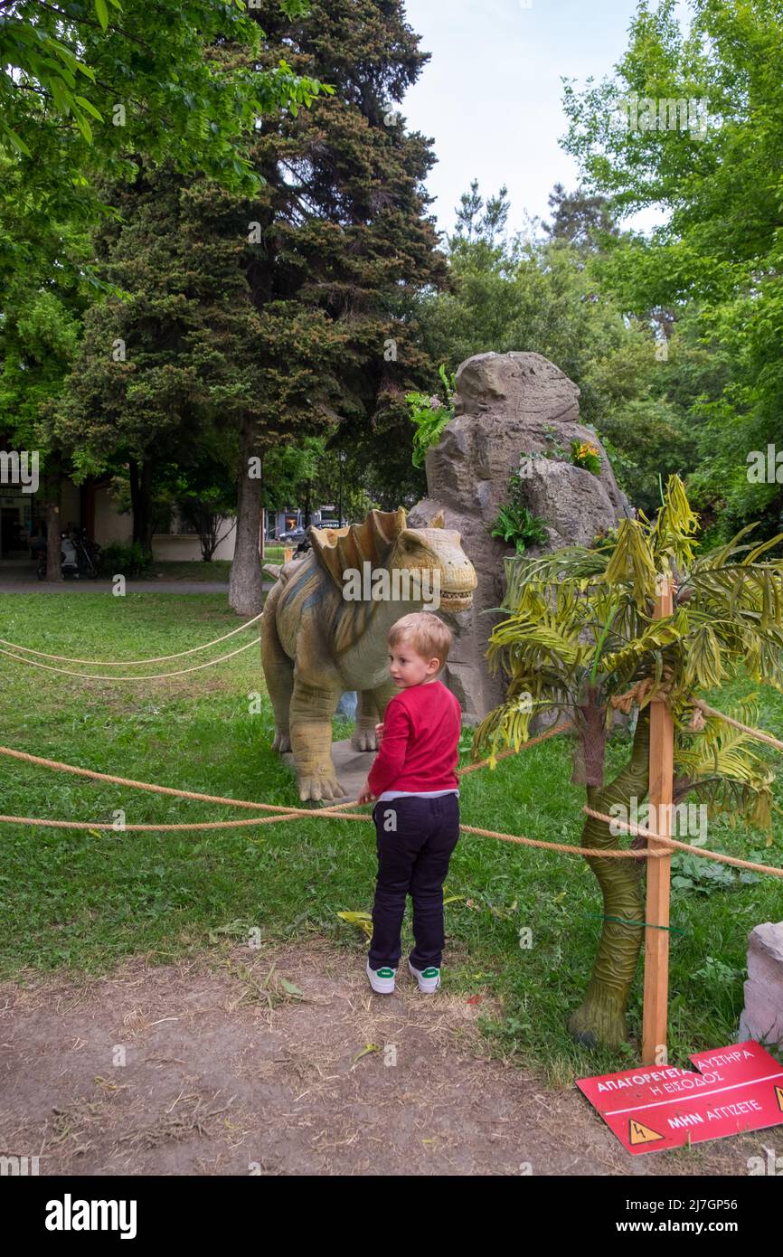 Cute little boy staring dinosaurs in a dinosaur festival Stock Photo ...