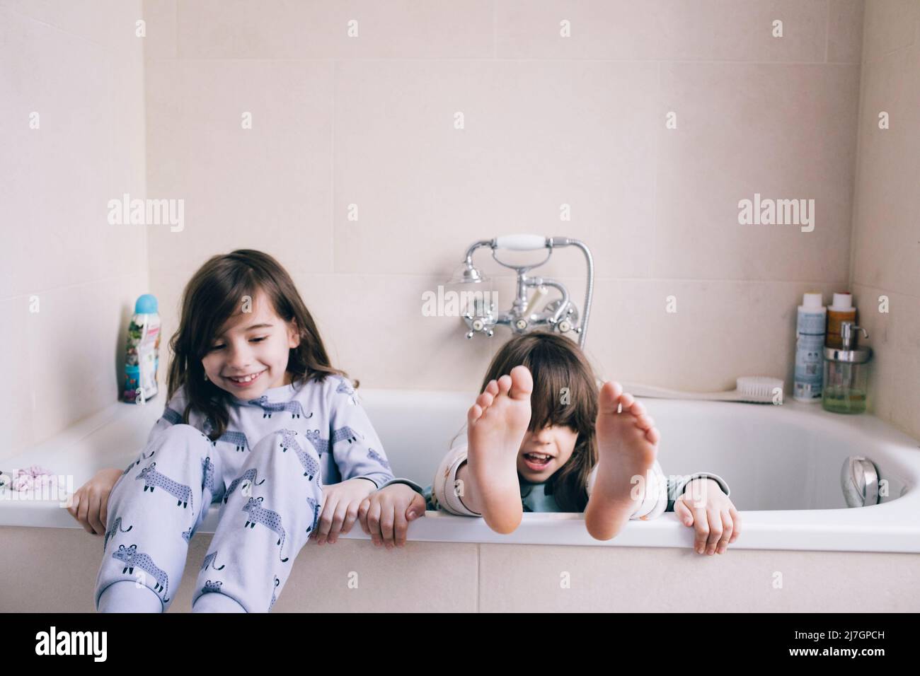 Playful girls enjoying together in bathtub Stock Photo - Alamy