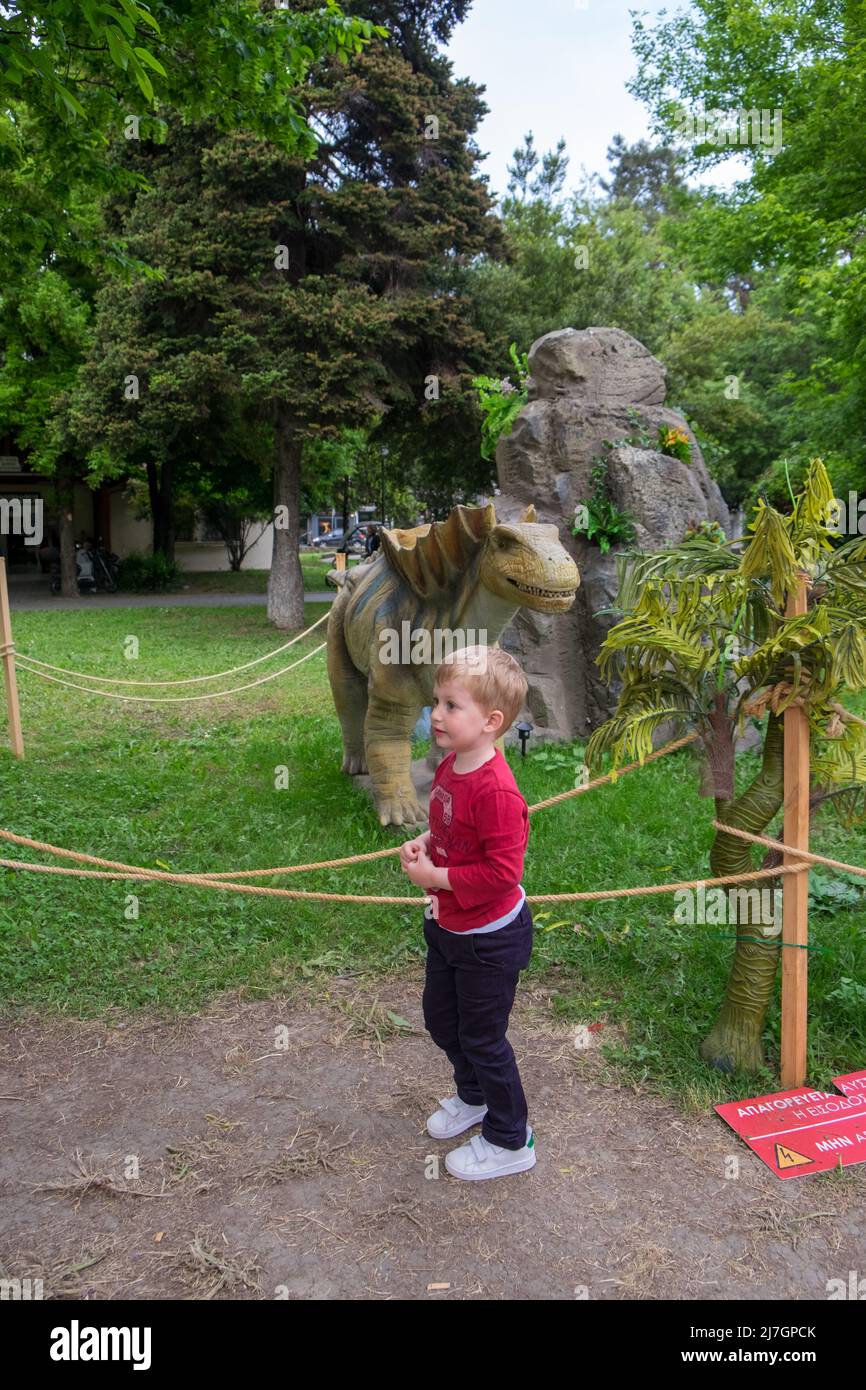 Cute little boy staring dinosaurs in a dinosaur festival Stock Photo ...