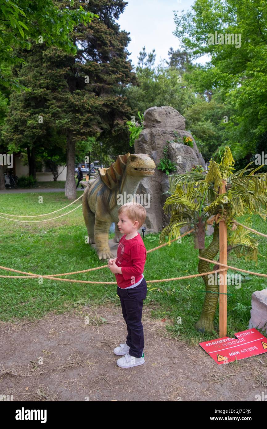 Cute little boy staring dinosaurs in a dinosaur festival Stock Photo ...