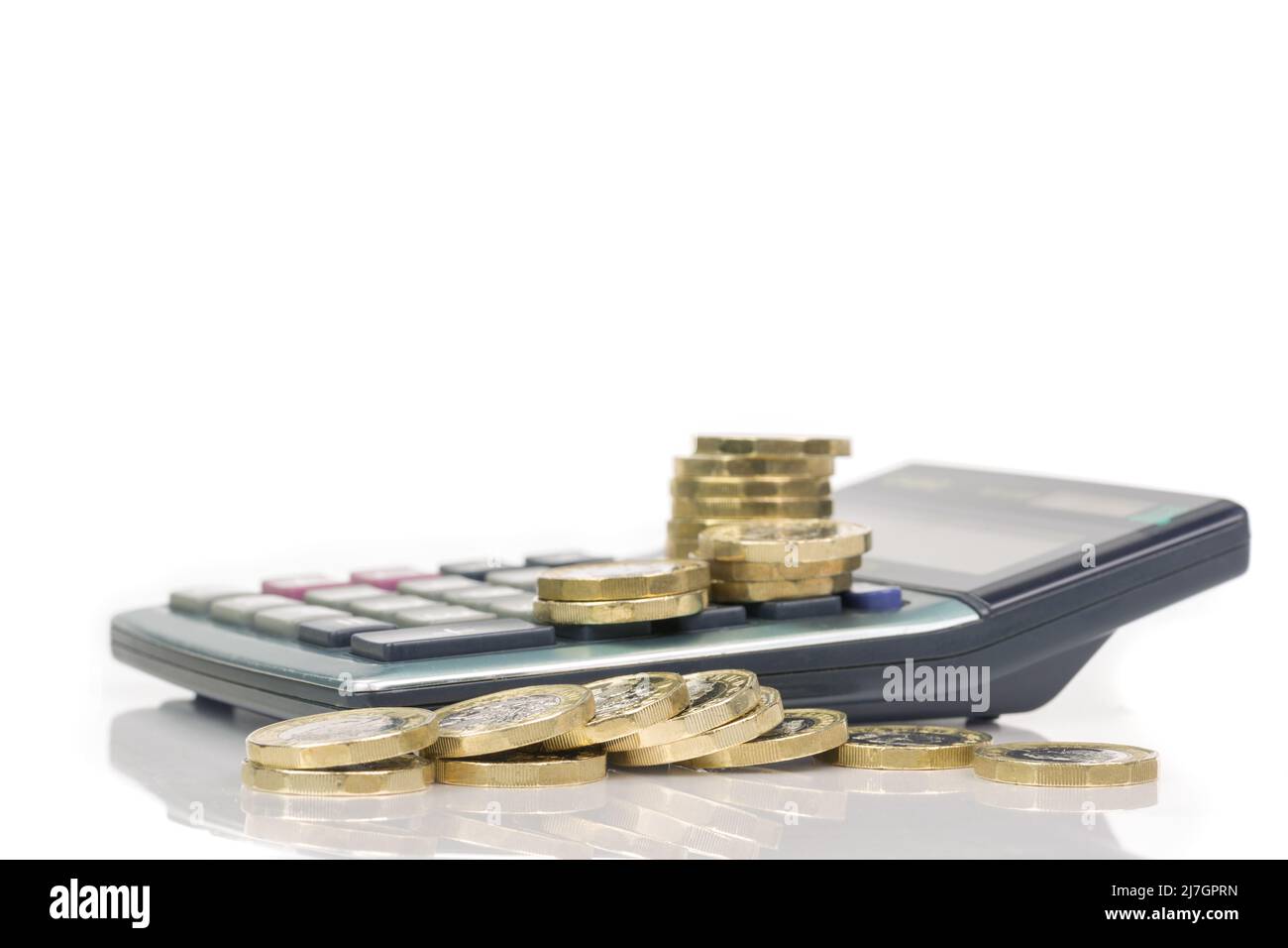 Calculator with UK Pound Sterling GBP gold coloured coins side-on ...