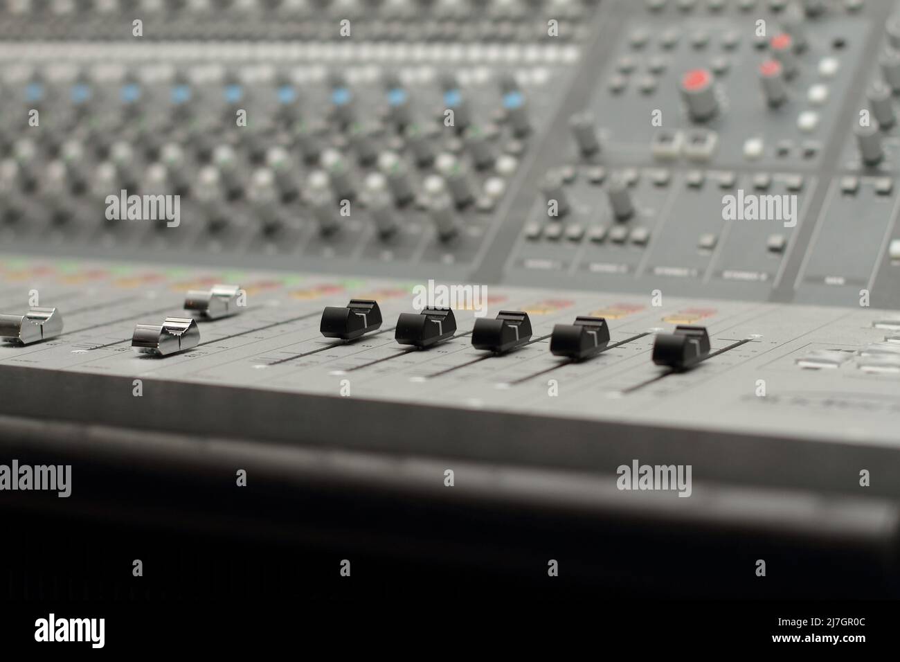 Recording studio mixing desk close up faders full screen with soft ...