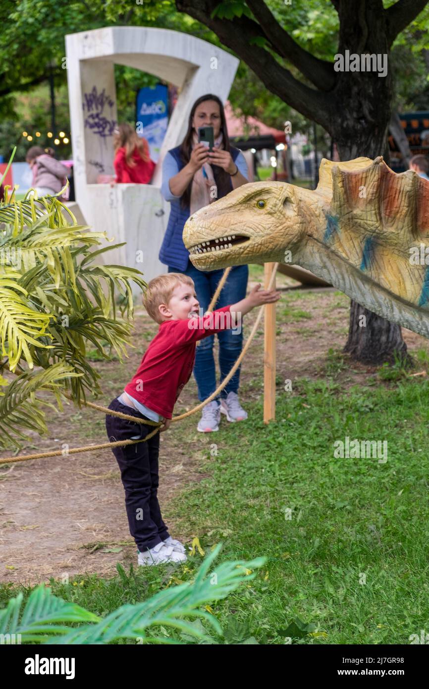 Cute little boy staring dinosaurs in a dinosaur festival Stock Photo ...