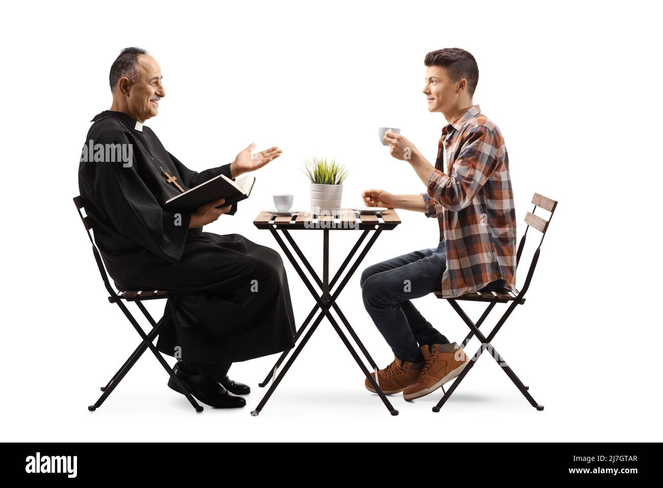Priest and a male student sitting at a table and having coffee isolated ...