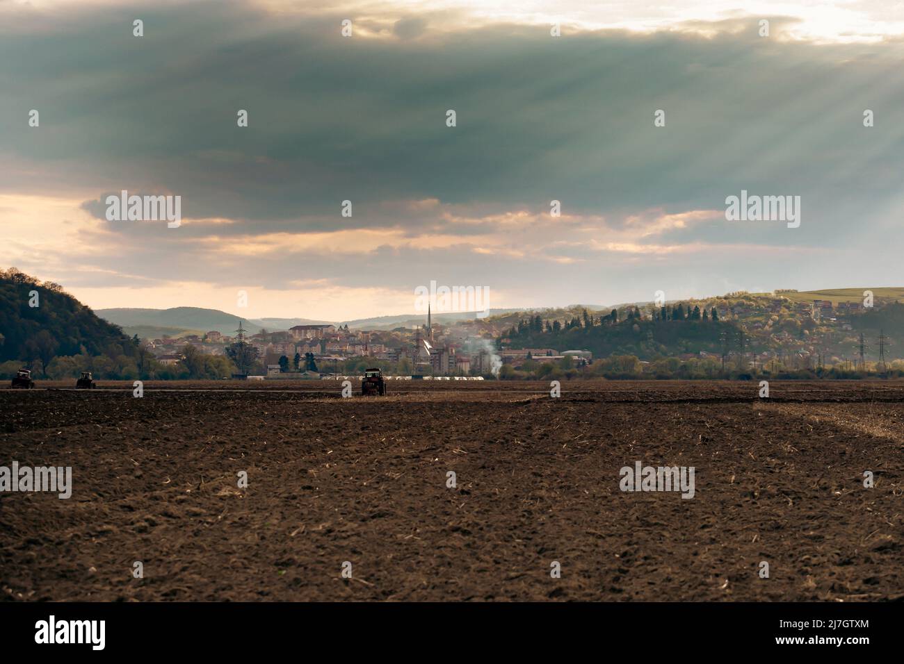 Cultivated field, agronomy, farming concept. Farmer in tractor ...