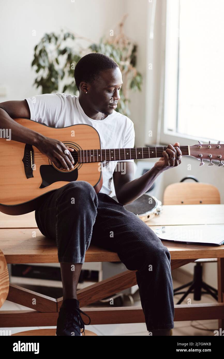 Man sitting practicing guitar hi-res stock photography and images - Alamy