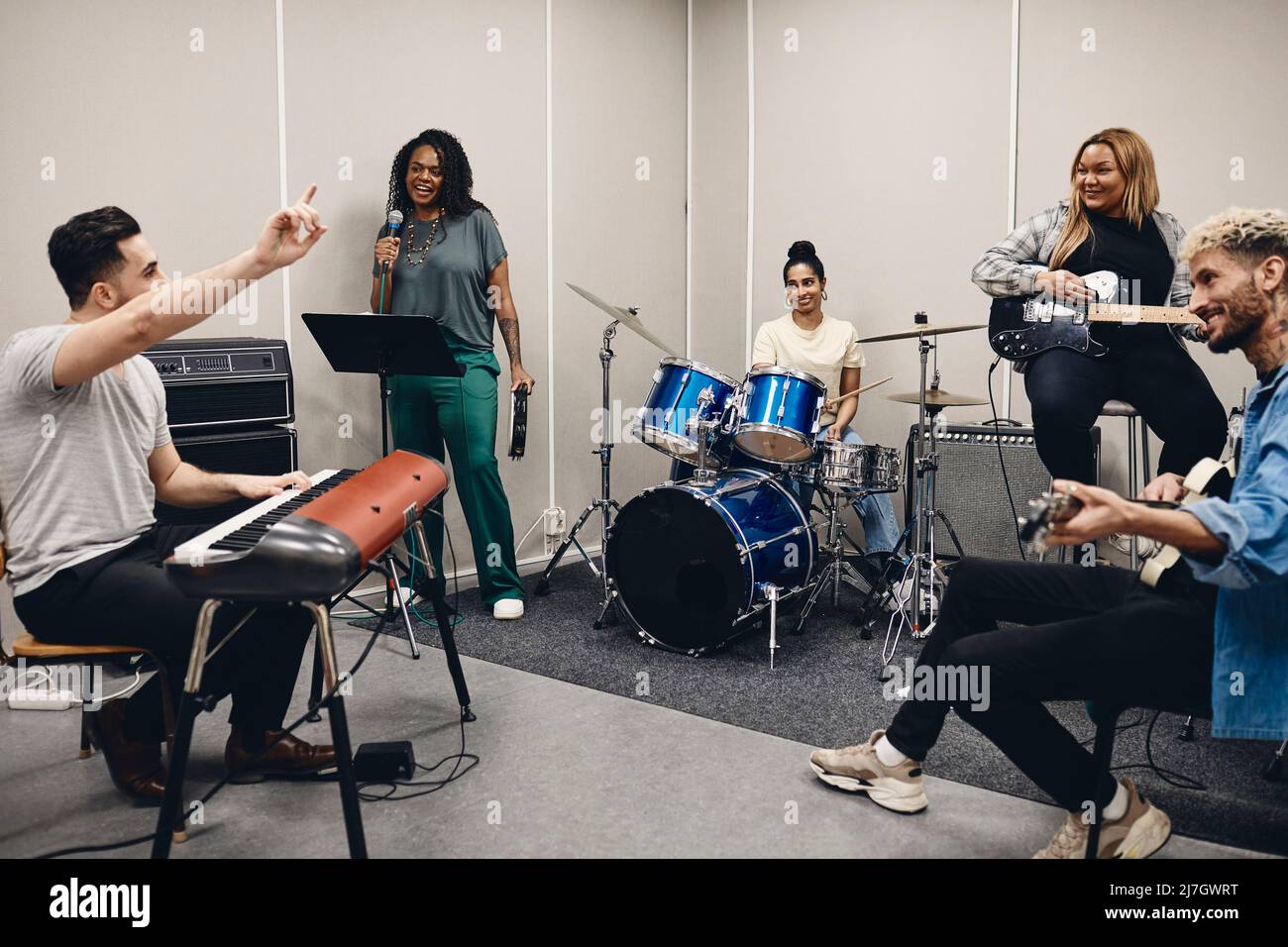 Multiracial men and women rehearsing together in classroom Stock Photo ...