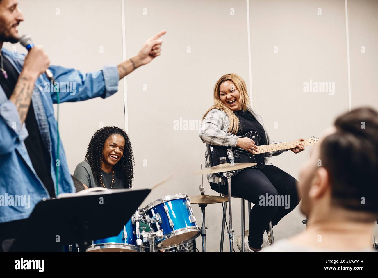 Happy multiracial men and women enjoying during rehearsal in classroom ...