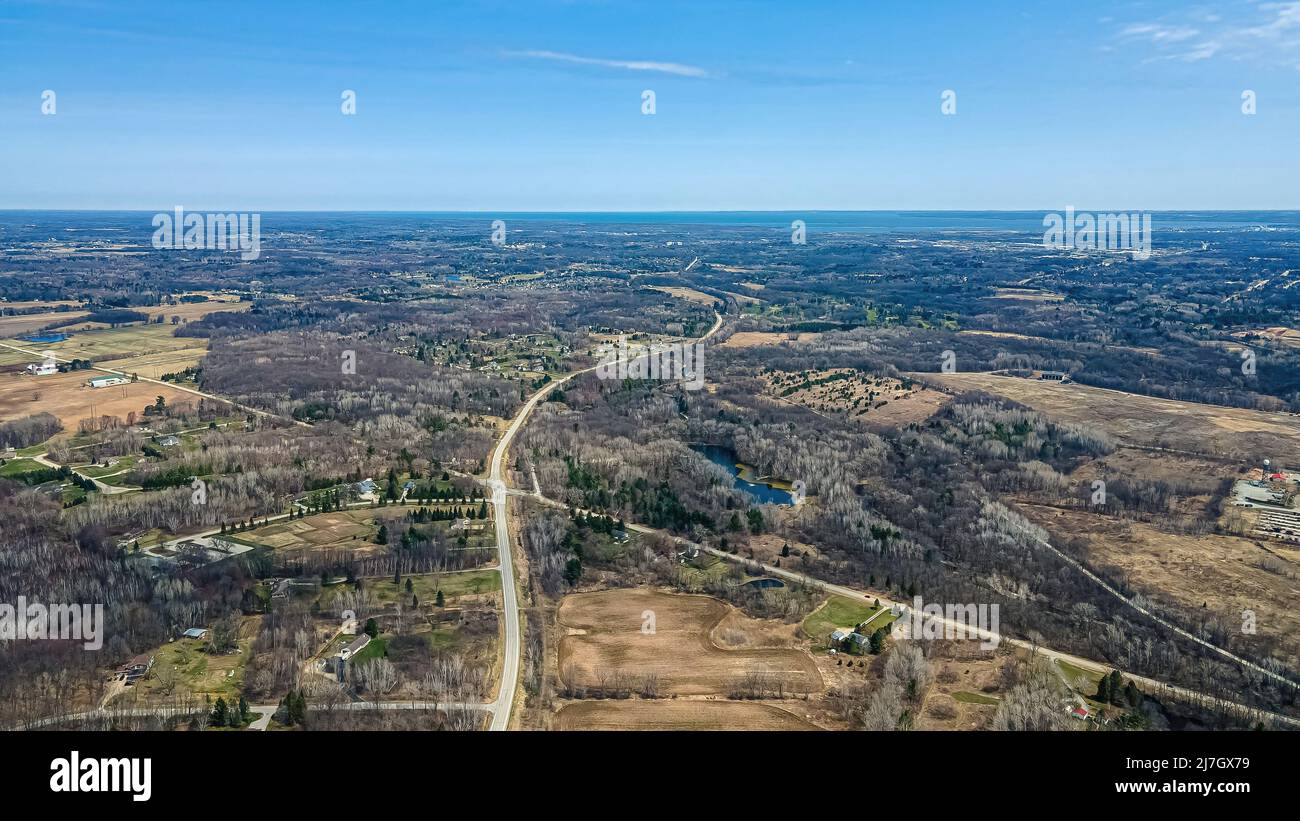 A springtime view to the horizon with a calm blue sky above. Signs of ...