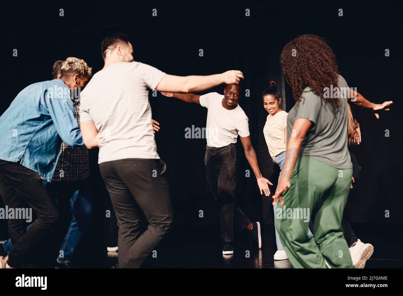 Multiracial male and female stage performers dancing during rehearsal ...