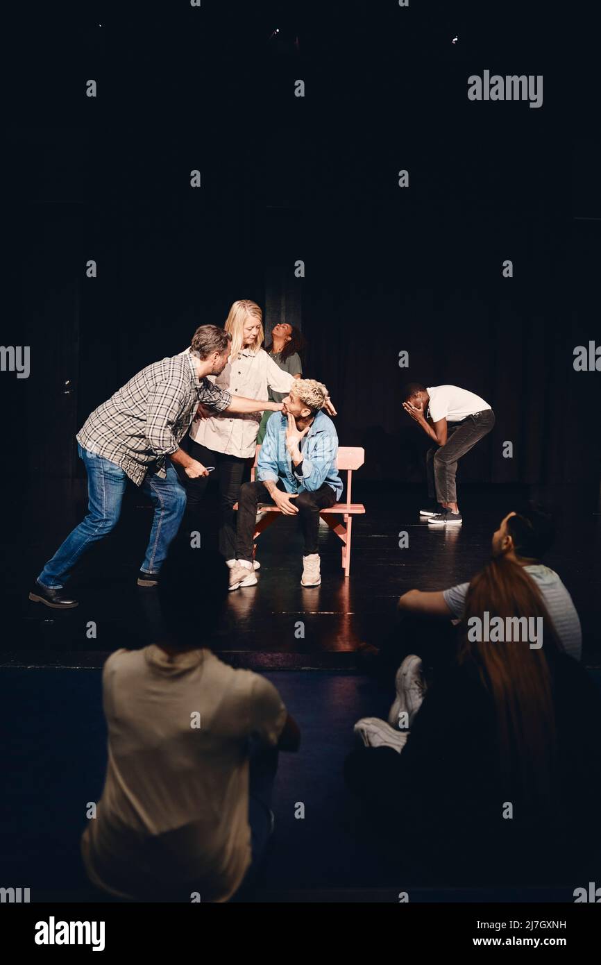 Artists looking at stage performers rehearsing on stage in class Stock ...
