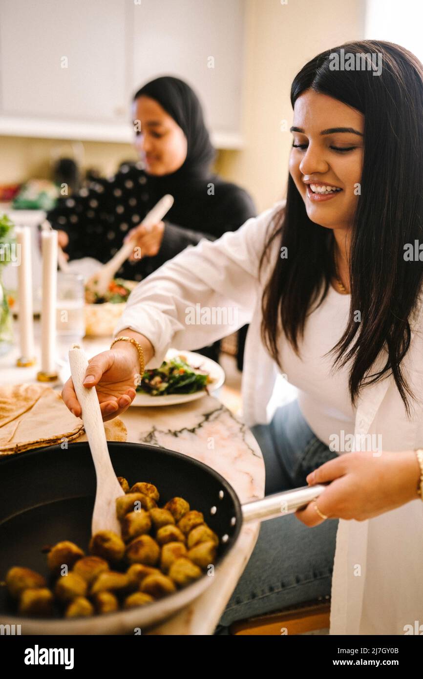 Young muslim woman serving hi-res stock photography and images - Alamy