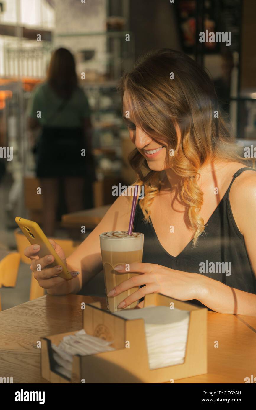 Girl drinks coffee in cafe hi-res stock photography and images - Alamy