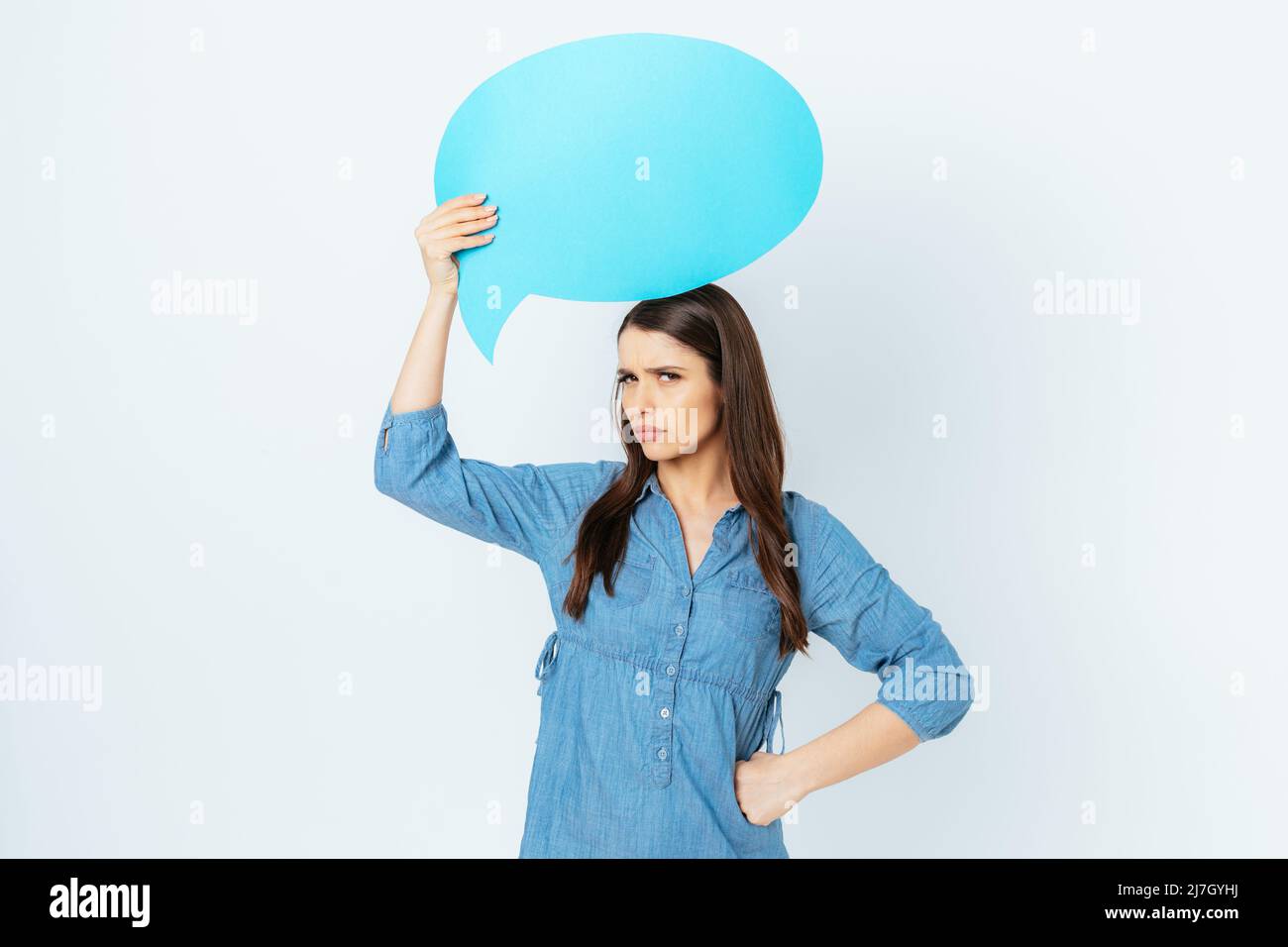Angry dissatisfied young woman with blank speech bubble looking ...
