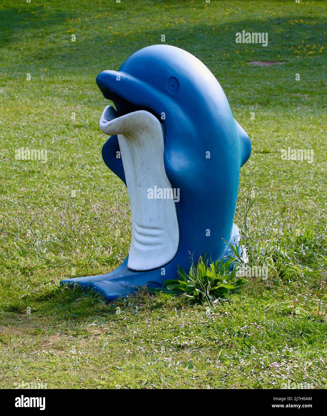 Blue and white plastic dolphin rubbish bin next to a children's ...