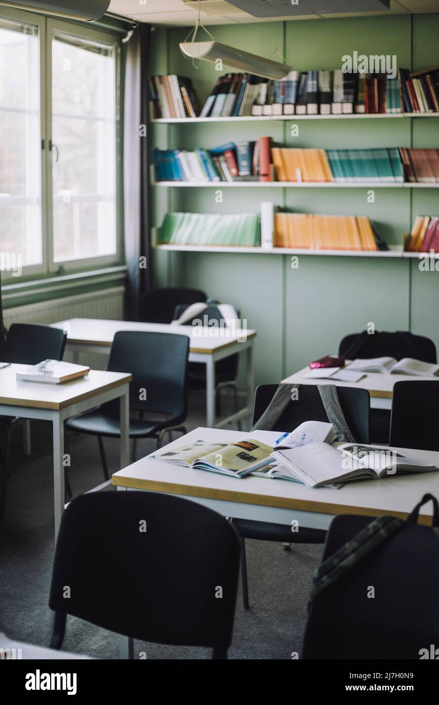 Empty classroom with books on desk Stock Photo - Alamy