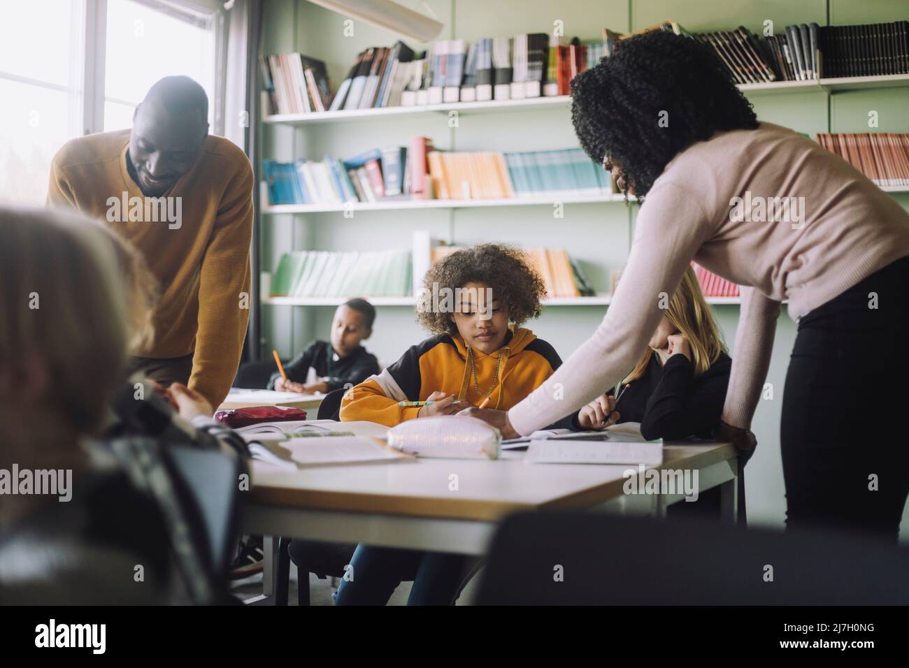 Teachers teaching students in classroom at school Stock Photo - Alamy