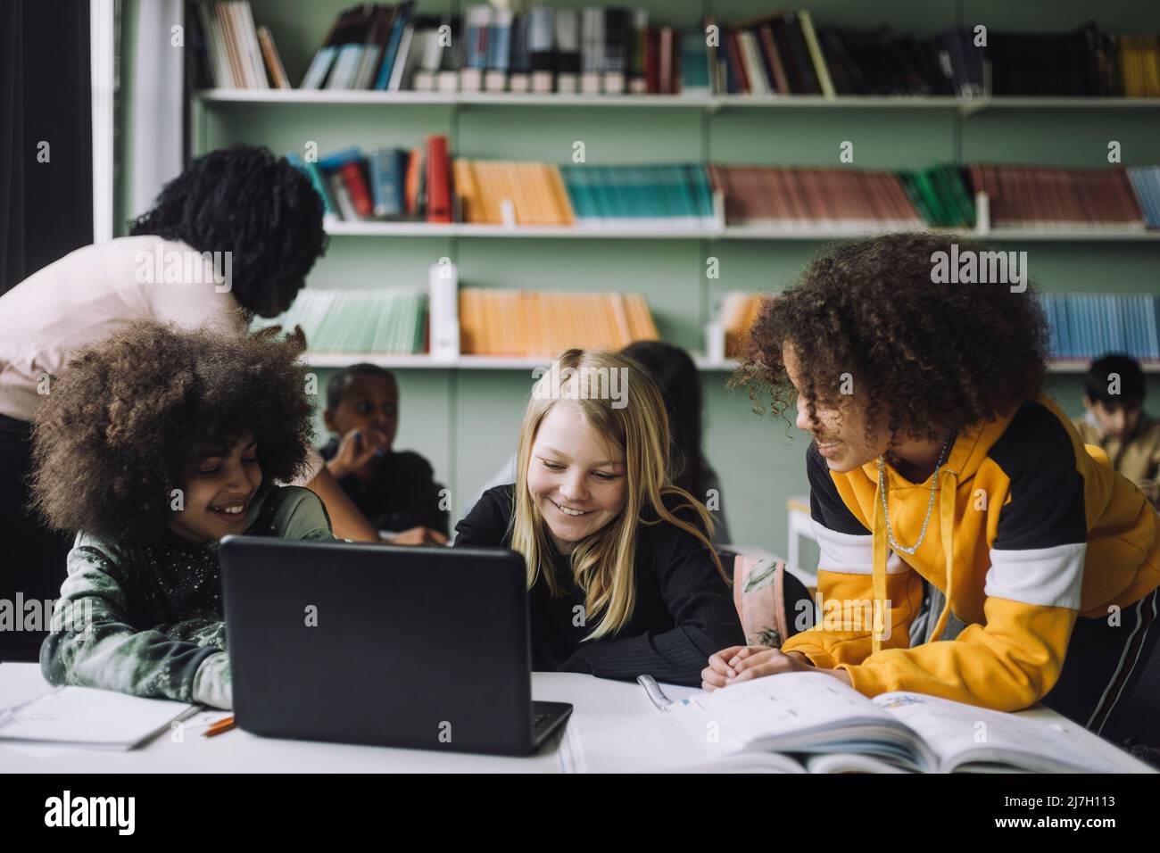 Portrait of diverse students studying together through e-learning in ...