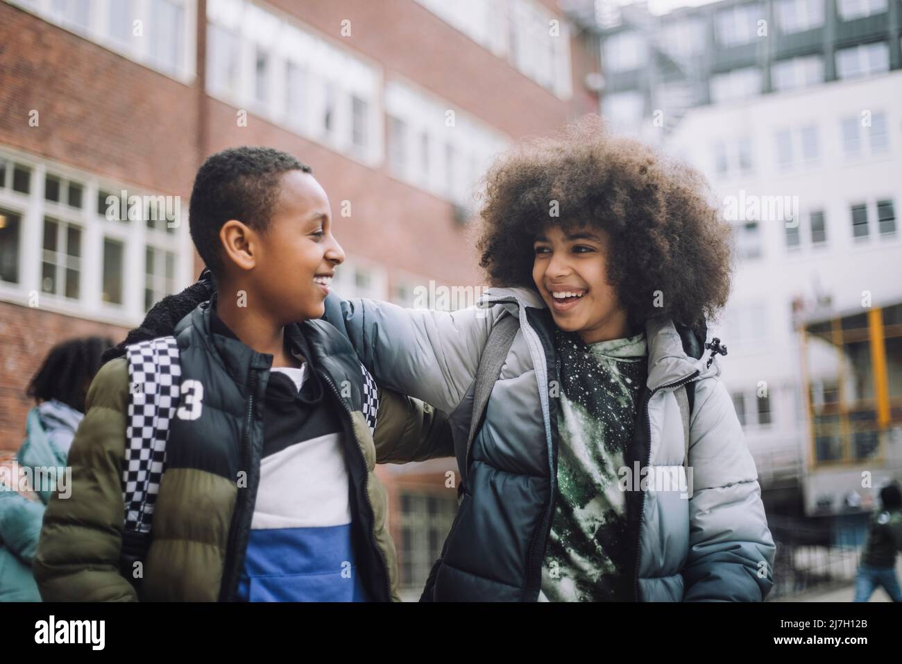 Happy friends with arm around each other in school campus Stock Photo ...