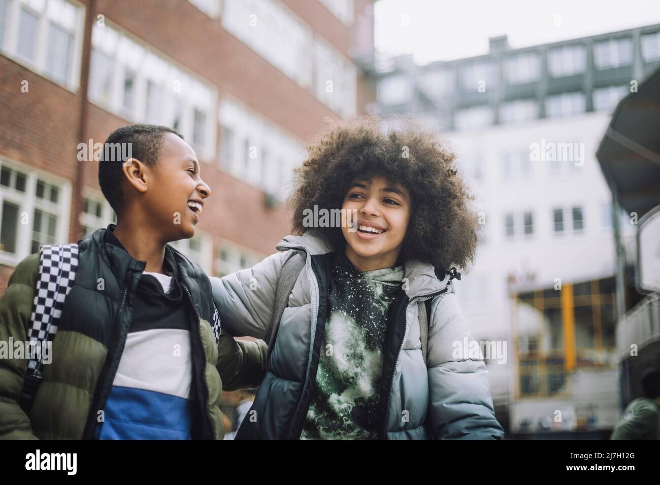 Friends in warm clothing enjoying at school campus Stock Photo - Alamy