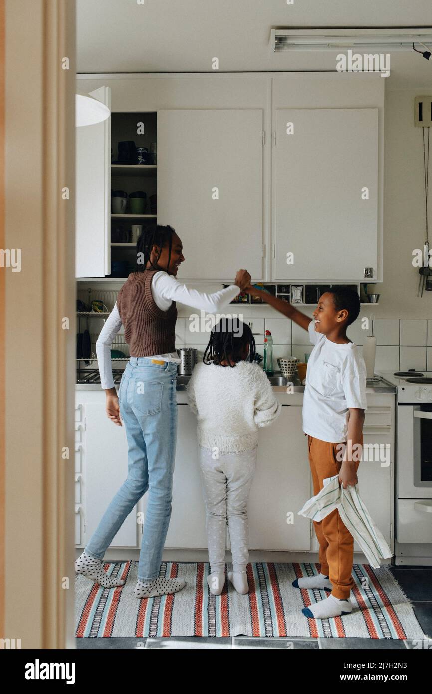 Child helping siblings in the home hi-res stock photography and images ...