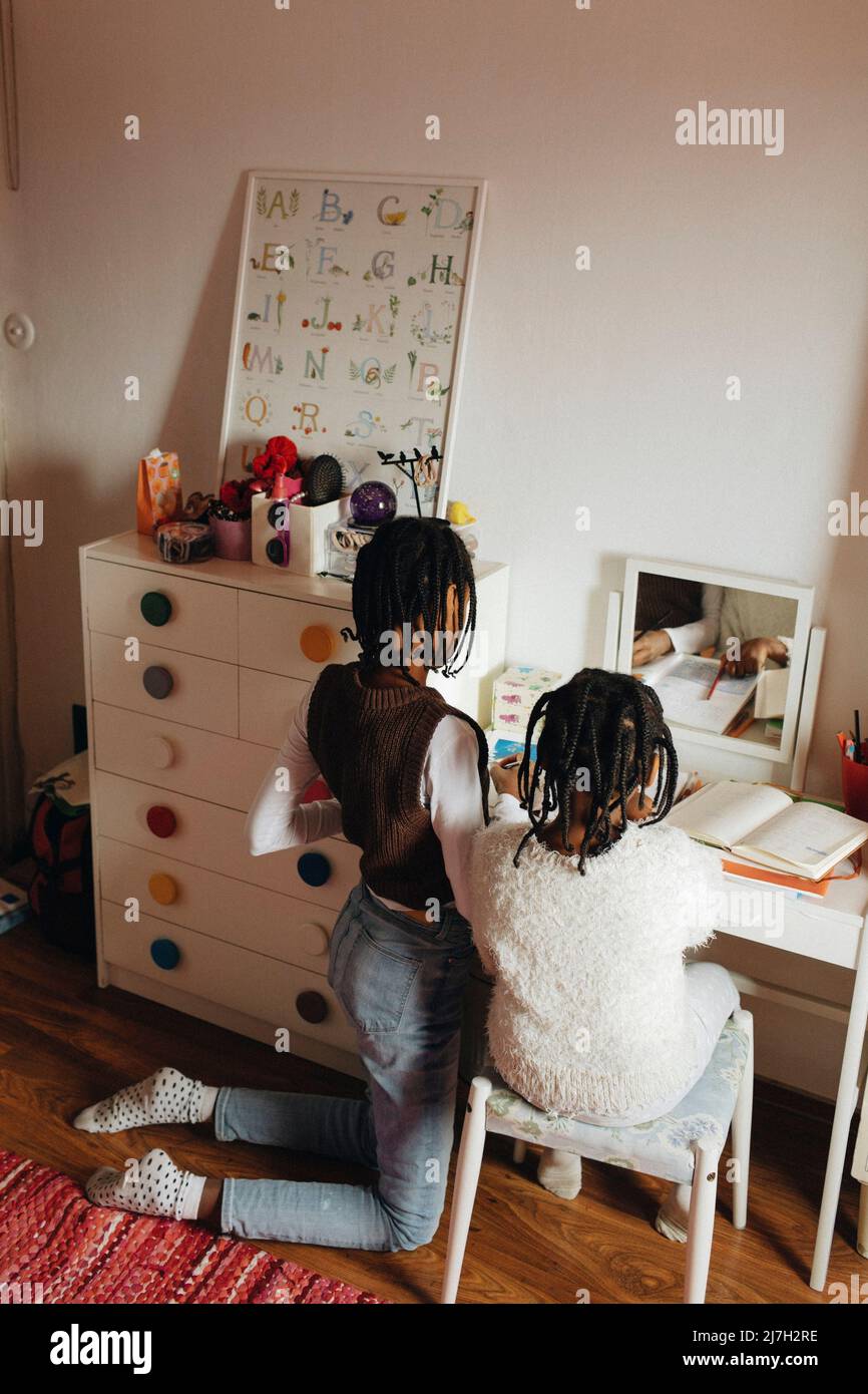 Sisters studying together in study room at home Stock Photo - Alamy