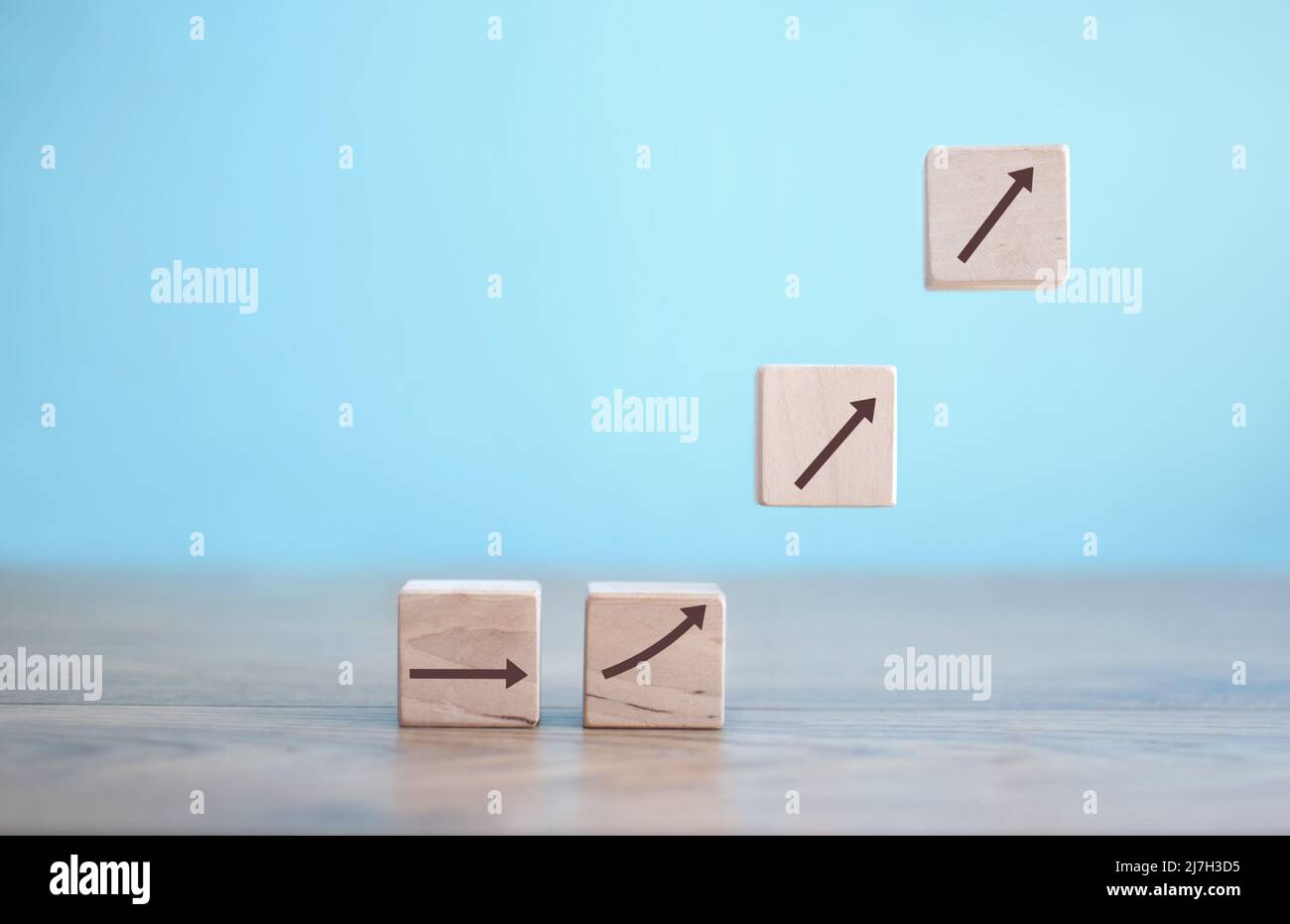 Business growth building blocks on podiums with arrows heading upwards ...