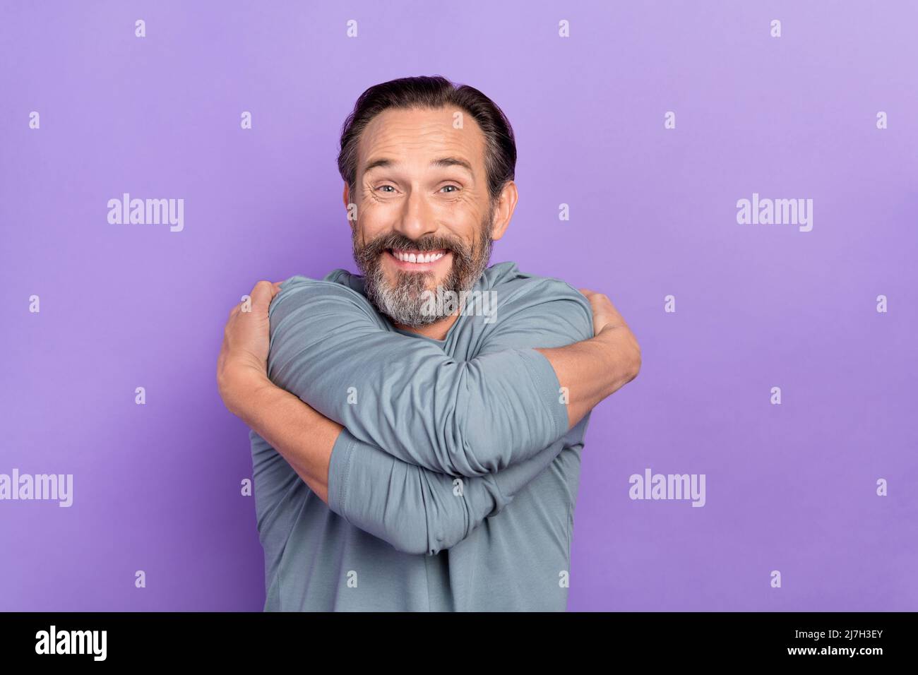 Portrait of handsome cheerful lovely man hug embrace his shoulders self ...