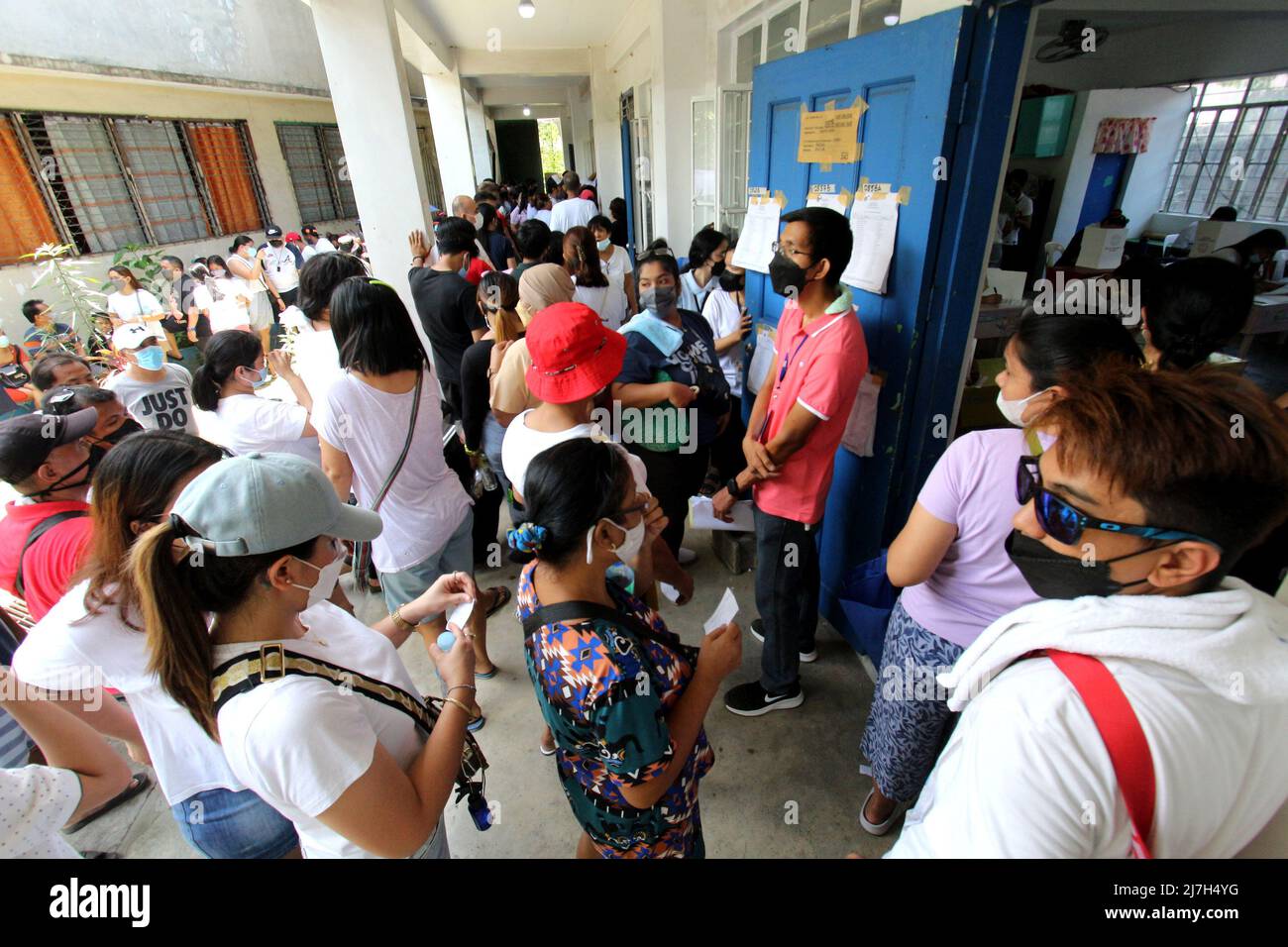 Voters queuing outside the school building and waiting their turn to ...