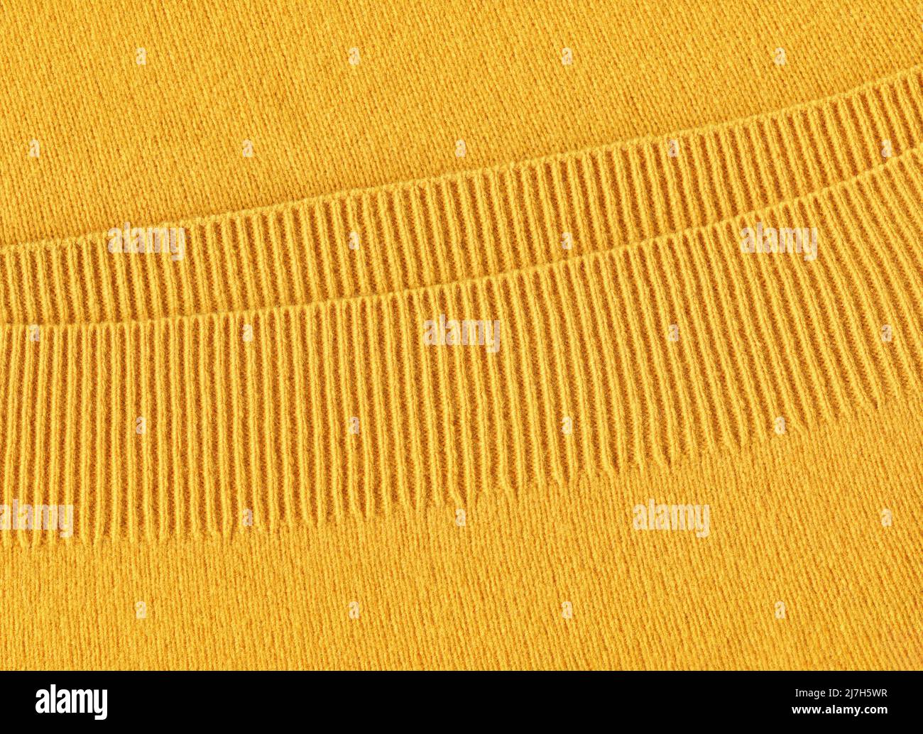 Handmade knitted texture, bright yellow background. Seasonal clothes ...