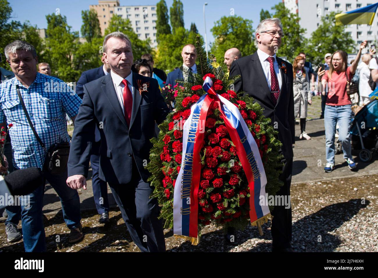 Russia's ambassador to Poland, Sergey Andreev (on the right) carries a ...