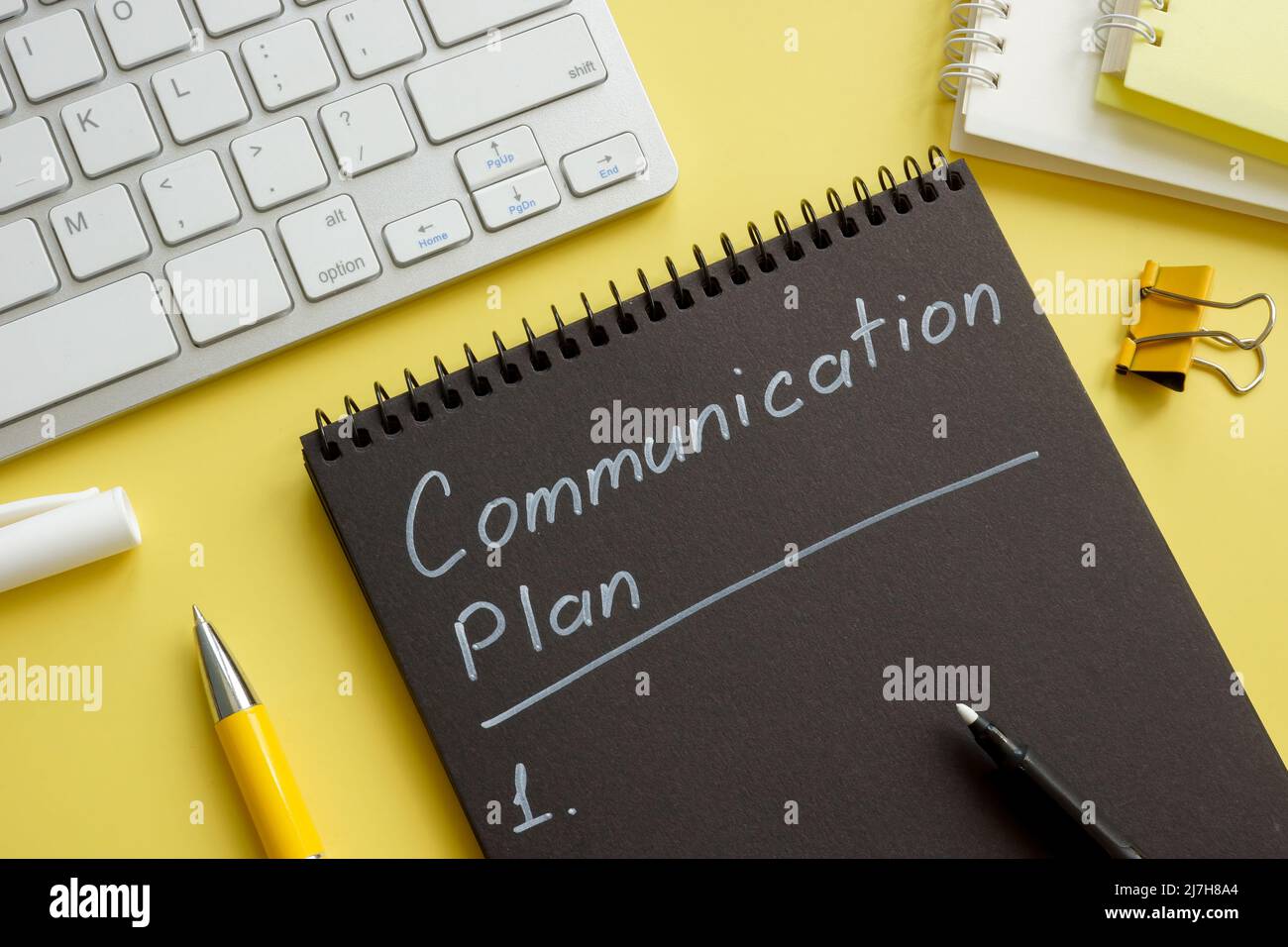Communication plan on the open black notebook Stock Photo - Alamy