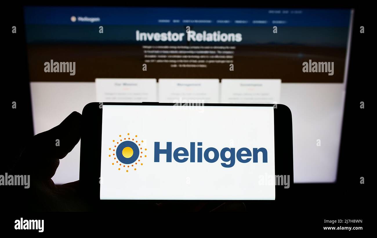 Person holding smartphone with logo of US renewable energy company ...