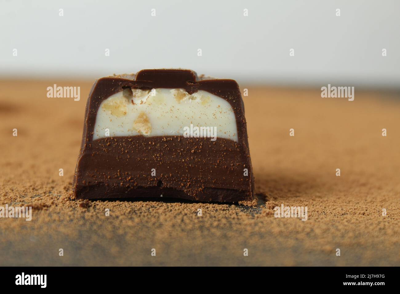 body chocolate candy with chocolate and white milk cream filling close ...