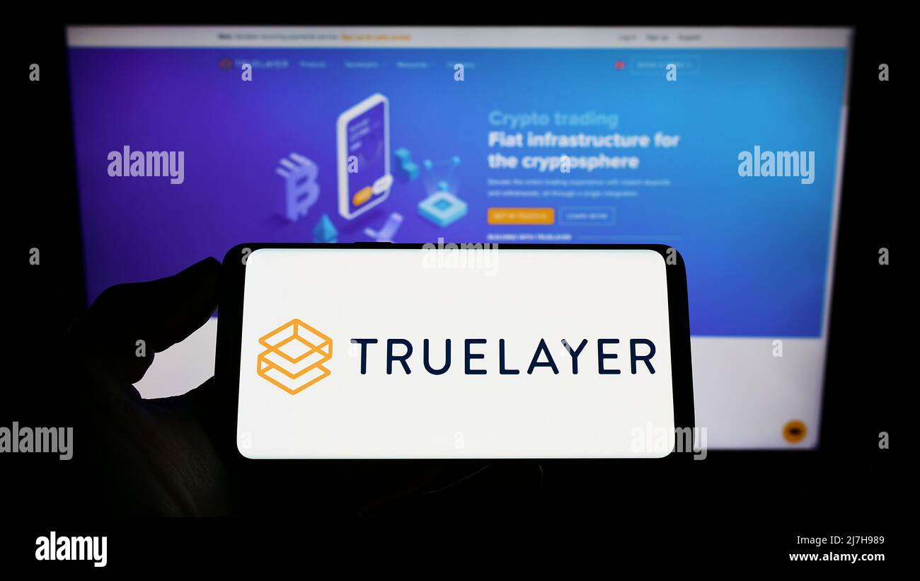 Person holding mobile phone with logo of British fintech company ...